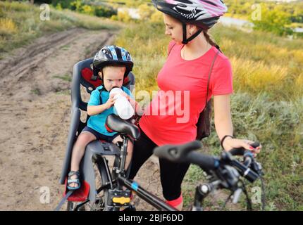 Boy in a Protective Helmet Drinking from a Cup: The Essence of ...