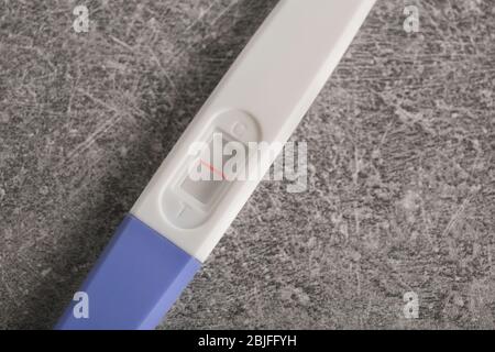 Positive pregnancy test on grey stone surface Stock Photo - Alamy