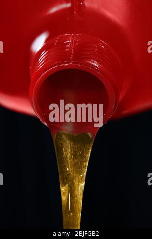 Pouring motor oil from red container isolated on white Stock Photo - Alamy