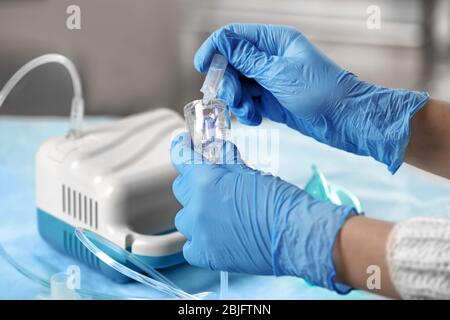 Doctor filling medication cup with remedy for inhalation therapy Stock ...
