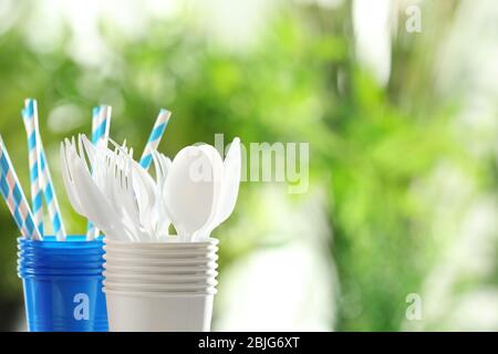 Plastic ware on blurred background outdoors Stock Photo - Alamy