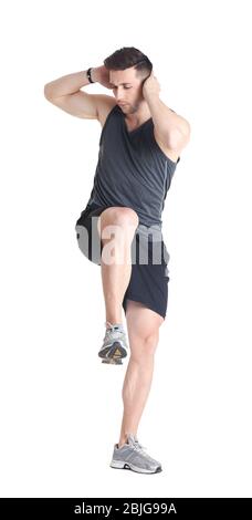 Handsome man doing bicycle crunch on white background Stock Photo - Alamy