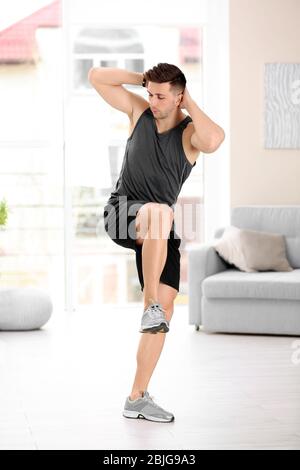 Handsome man doing bicycle crunch at home Stock Photo - Alamy