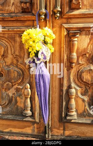 Umbrella with lilac flowers hanging on brick wall, closeup Stock Photo ...
