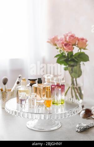 Stand with bottles of perfume on table Stock Photo - Alamy