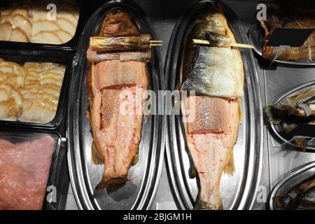 Tray with smoked fish in supermarket Stock Photo - Alamy