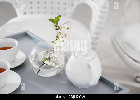 Tea set and beautiful flowers on table at home Stock Photo - Alamy