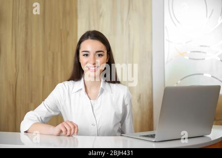Young smiling receptionist in dental clinic Stock Photo - Alamy