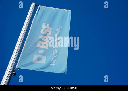 A flag of the chemical company BASF on a rice field in the Philippines ...
