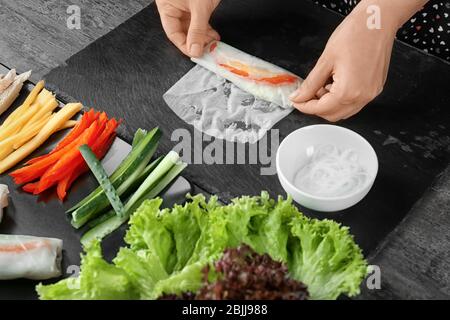 Preparing vegetarian spring rolls on chop board. Picture of traditional ...