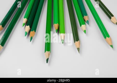 Green pencils of different shades on white background Stock Photo - Alamy