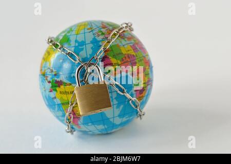 Lock and chain on the globe of the world Stock Photo - Alamy