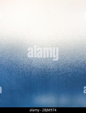 Blurred blue gradient background with grainy texture creating an ...