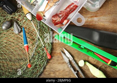 Modern fishing equipment on table Stock Photo - Alamy