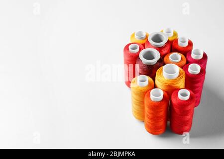 Red and orange threads of different shades on white background Stock ...