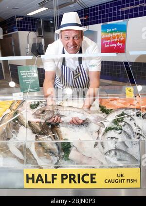 EDITORIAL USE ONLY Morrisons' Fishmonger Andrew Speight prepares whole ...