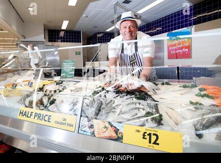 EDITORIAL USE ONLY Morrisons' Fishmonger Andrew Speight prepares whole ...