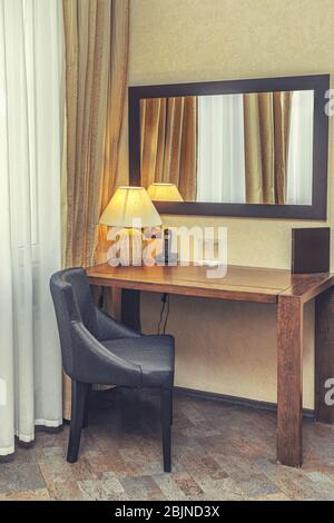 Comfortable workplace near light wall in room Stock Photo - Alamy