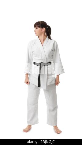 Female karateka on training in white kimono sitting on the floor, dark ...
