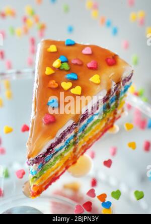 Tasty rainbow cake with caramel topping on glass stand Stock Photo - Alamy
