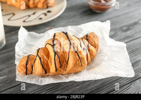 Delicious croissant with chocolate syrup on white background Stock ...