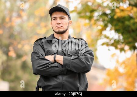 Young Male Security Guard Standing Beside Car Parking Machine Stock ...