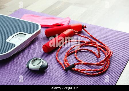 Jumping rope, timer and bathroom scales on wooden background Stock ...