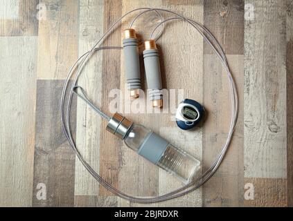 Jumping rope, timer and bottle on wooden background Stock Photo - Alamy