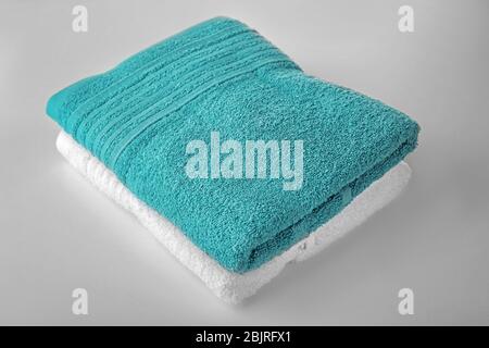 Soft terry towels on light table against white background Stock Photo ...
