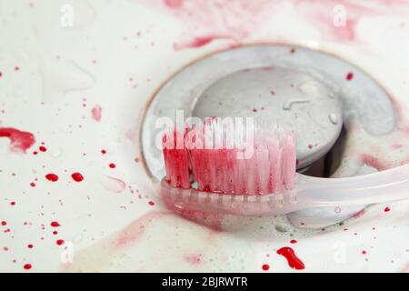 toothbrush with blood in the sink and toothpaste bleed gum copy space ...