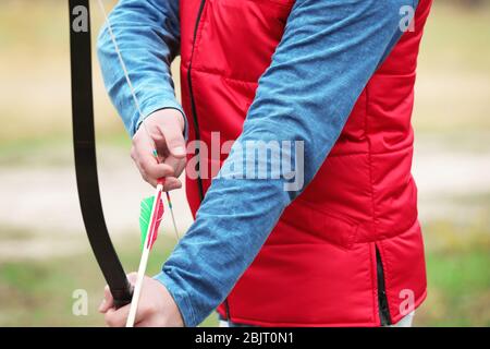 Woman practicing archery outdoors, closeup Stock Photo - Alamy