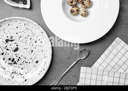 Set of dinnerware with ingredients on grey background Stock Photo - Alamy