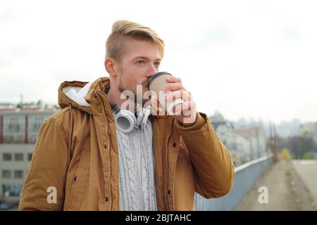 Portrait of trendy hipster drinking coffee outdoors Stock Photo - Alamy