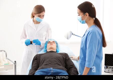 Professional beautician teaching trainee in salon. Apprenticeship ...