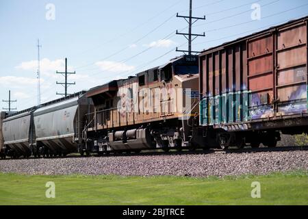 Geneva, Illinois, USA. A helper locomotive cut in mid train helps to ...