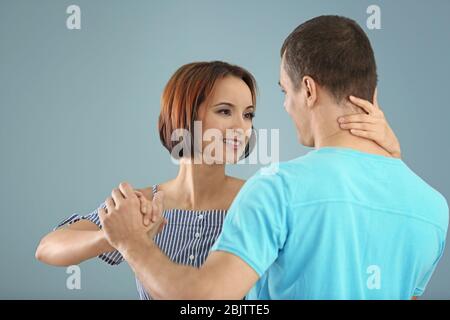 Cute loving couple dancing against light background Stock Photo - Alamy