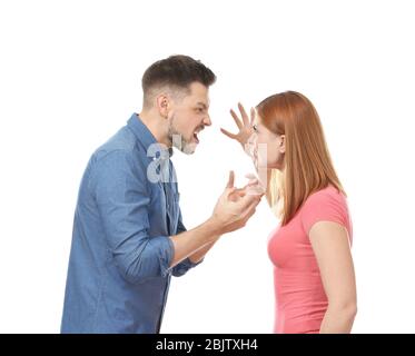 Emotional couple during quarrel on light background Stock Photo - Alamy