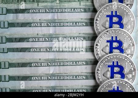 Silver bitcoins on dollar bills Stock Photo - Alamy