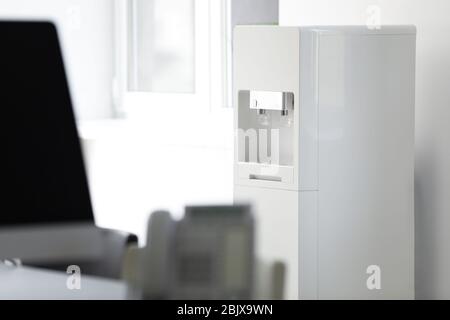 Modern water cooler in office, closeup Stock Photo - Alamy