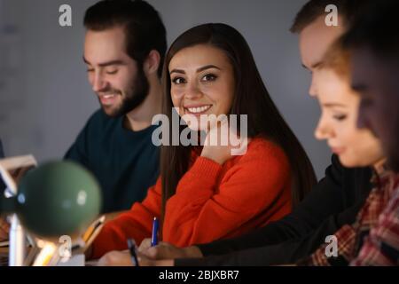 Students doing homework together indoors late at night Stock Photo - Alamy