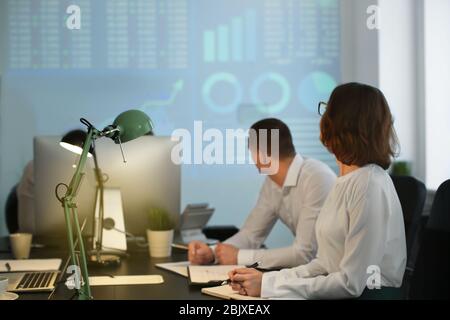 Office employees watching presentation during meeting. Forex concept ...
