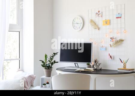 Workplace with mood board and computer in modern room Stock Photo - Alamy