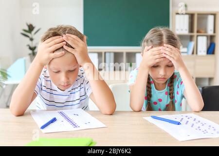Pupils passing difficult school test in classroom Stock Photo - Alamy