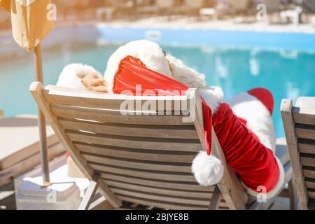 Santa Claus resting near swimming pool at resort Stock Photo - Alamy