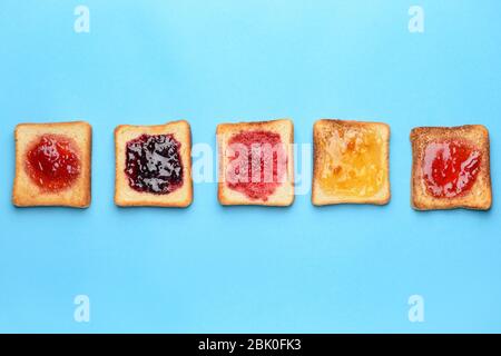 Tasty toasted bread with different jams on white background Stock Photo ...