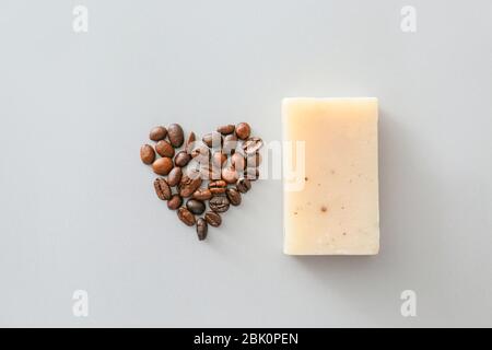 Soap with heart shape made of coffee beans on grey background Stock ...