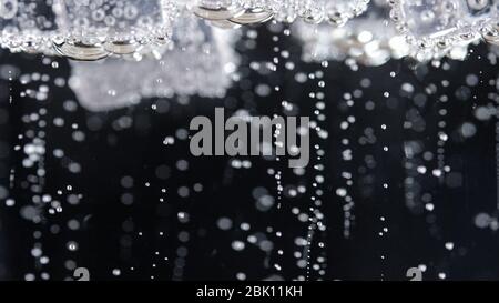 ice cube in fizzy splashing water with soda bubble Stock Photo - Alamy