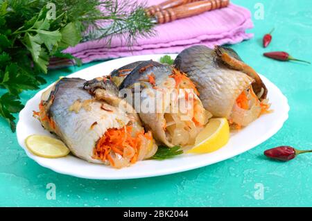 Baked herring stuffed with vegetables. Tasty fish rolls Stock Photo - Alamy