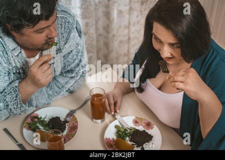 Caucasian plus size woman eating breakfast at home smiling with hand ...