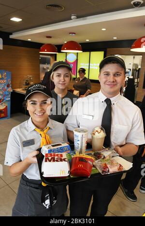 Portrait of three McDonalds restaurant staff in uniform in the the UK ...